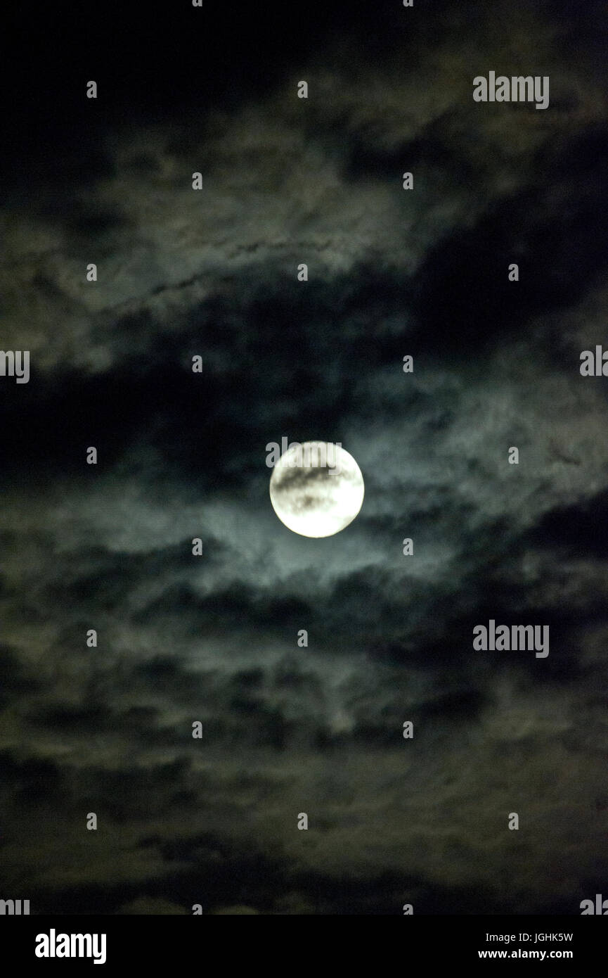 Moon shining through clouds Stock Photo - Alamy
