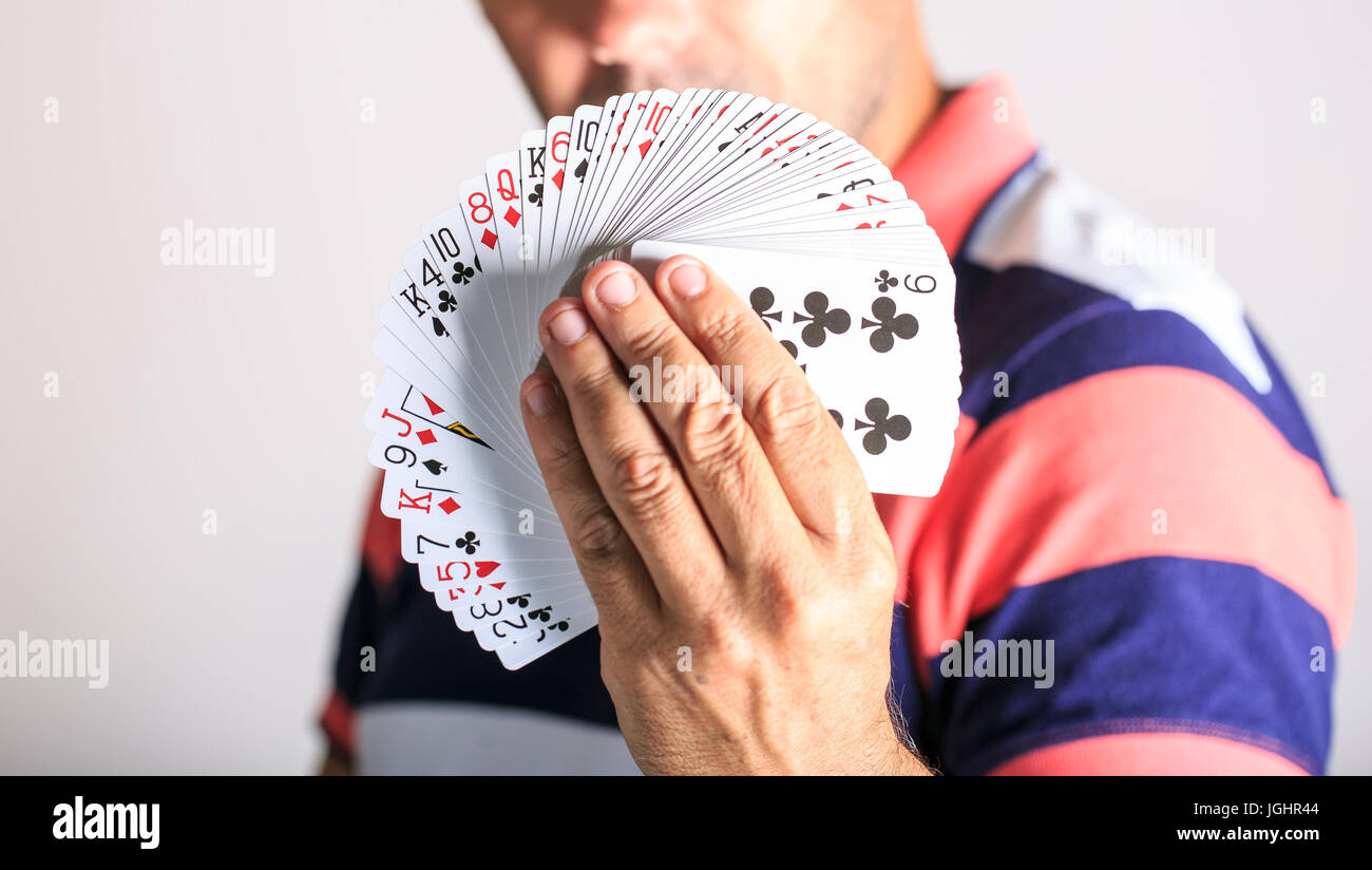 Man showing playing card in his hand Stock Photo - Alamy