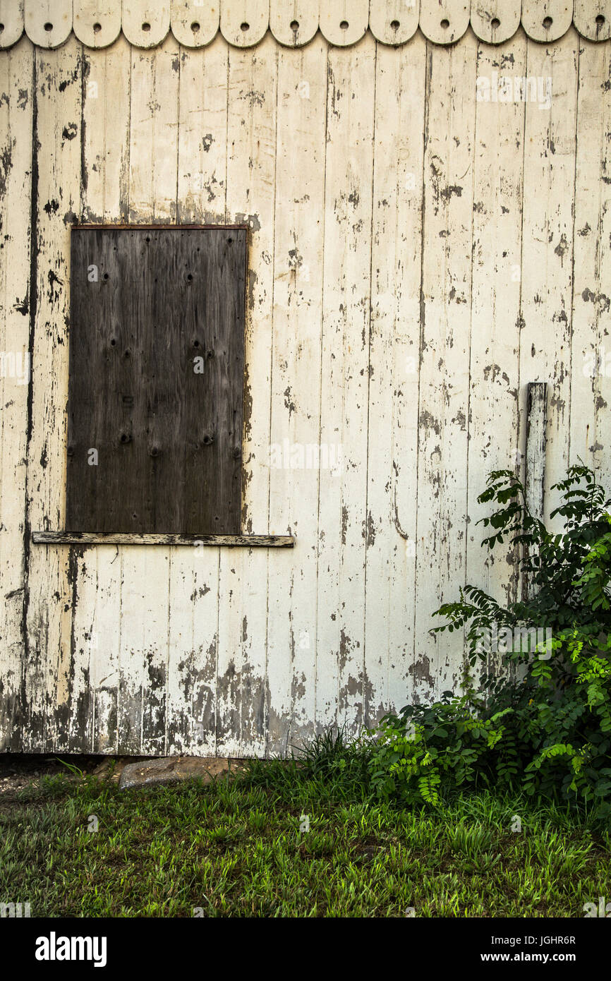 Abandoned white painted exterior barn wall with boarded windows Stock ...