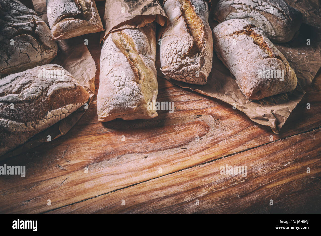 Lots of different bread sorts on wood background Stock Photo - Alamy