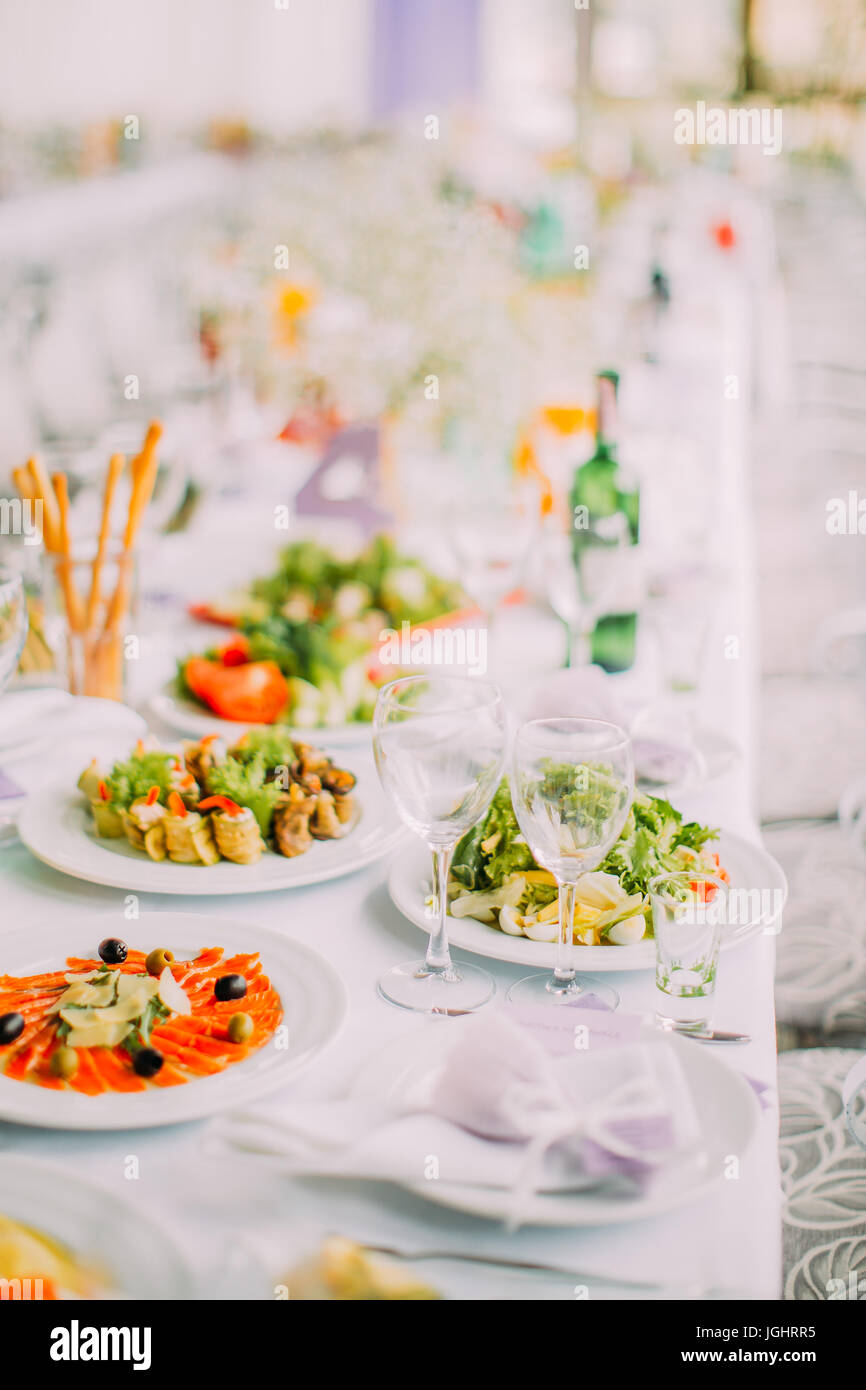 Different types of dishes placed on the wedding table set Stock Photo ...