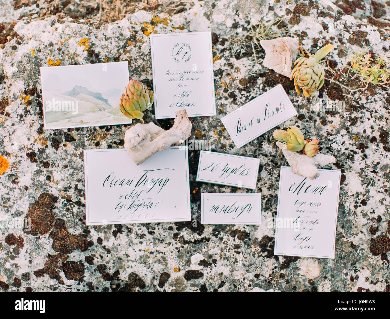 The close-up photo of the different postcards placed on the stone and ...