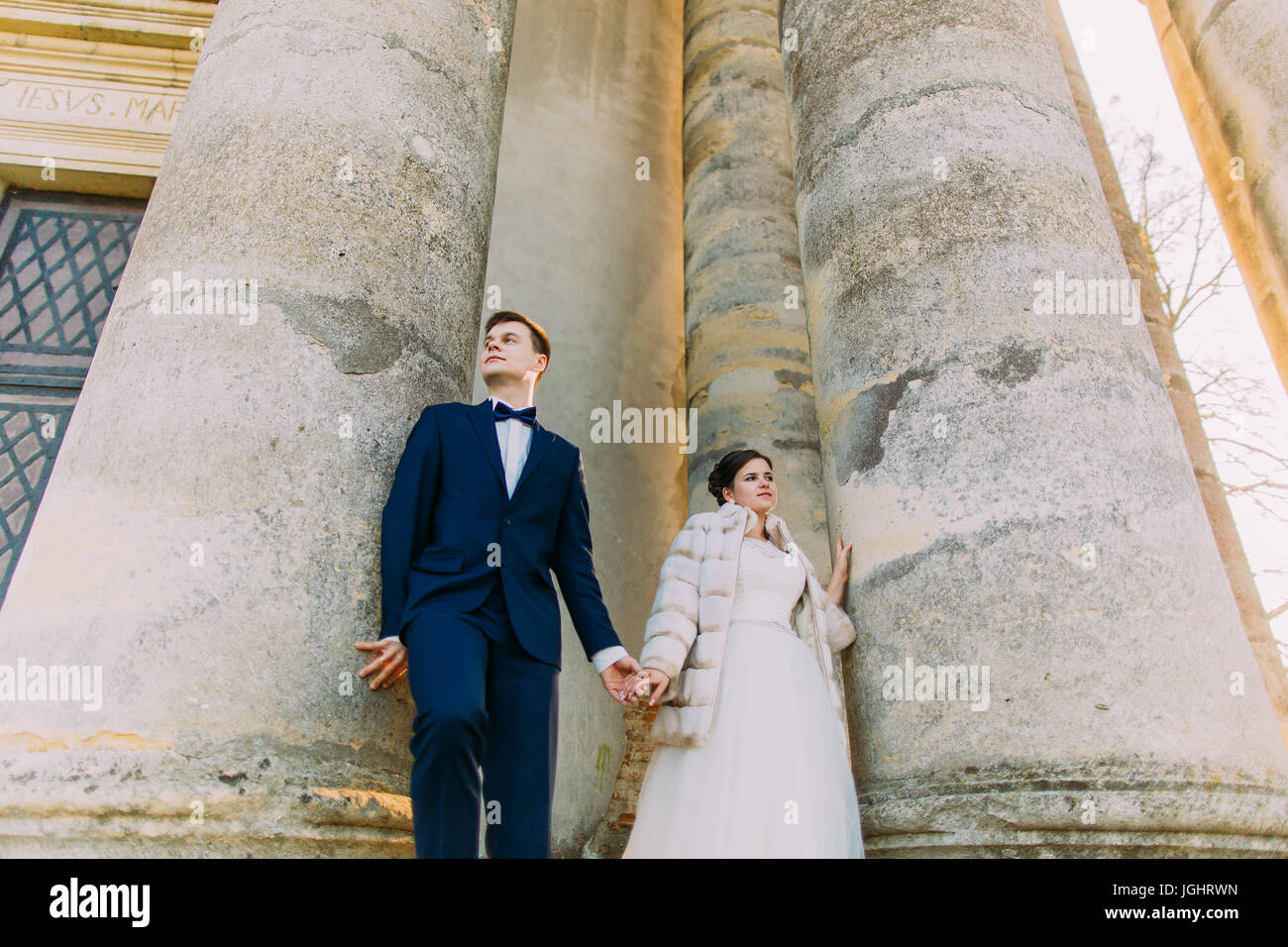 The down view of the newlywed couple holding hands while standing near ...