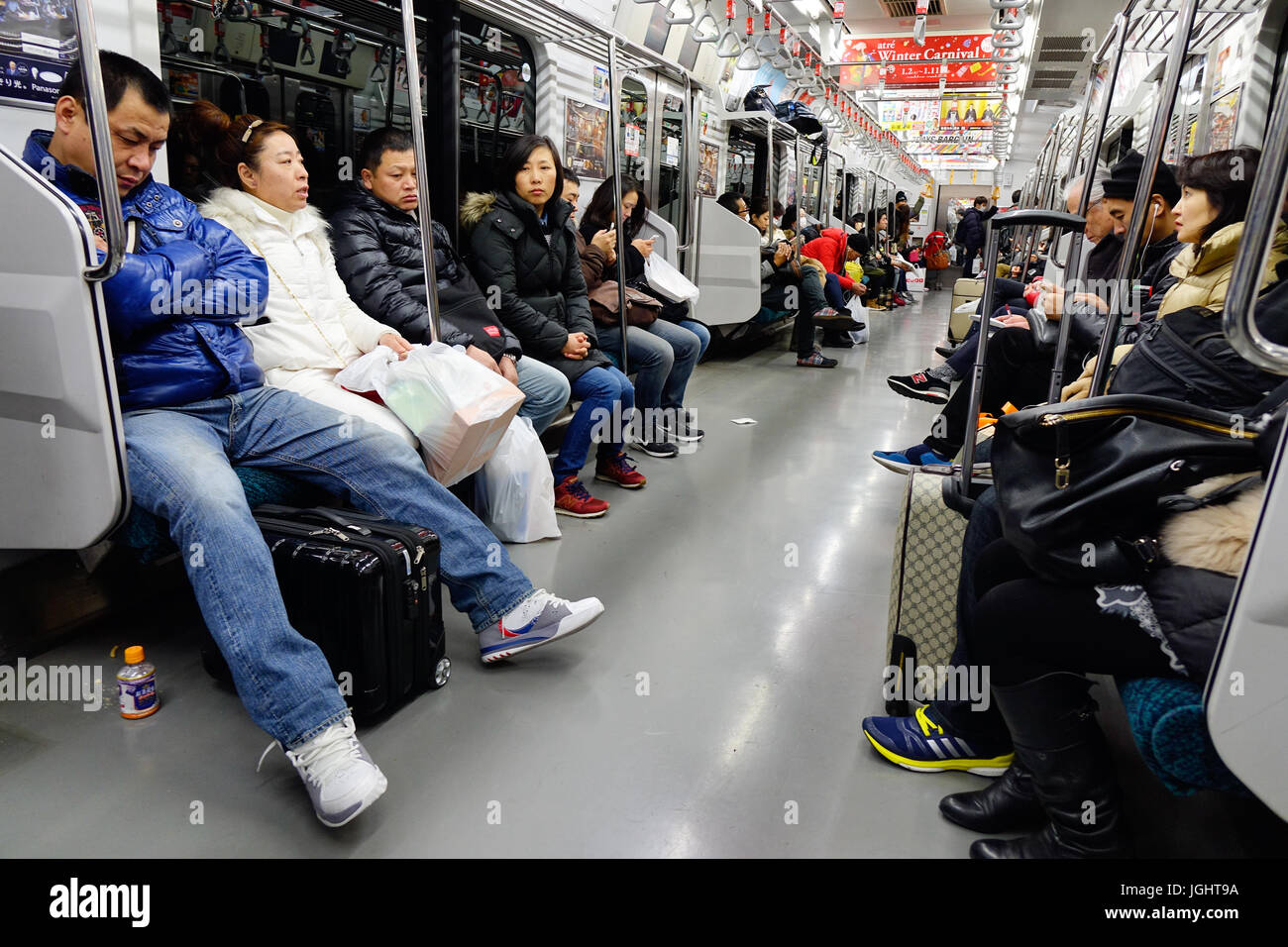Tokyo, Japan - Jan 1, 2016. People sitting in JR subway train in Tokyo ...