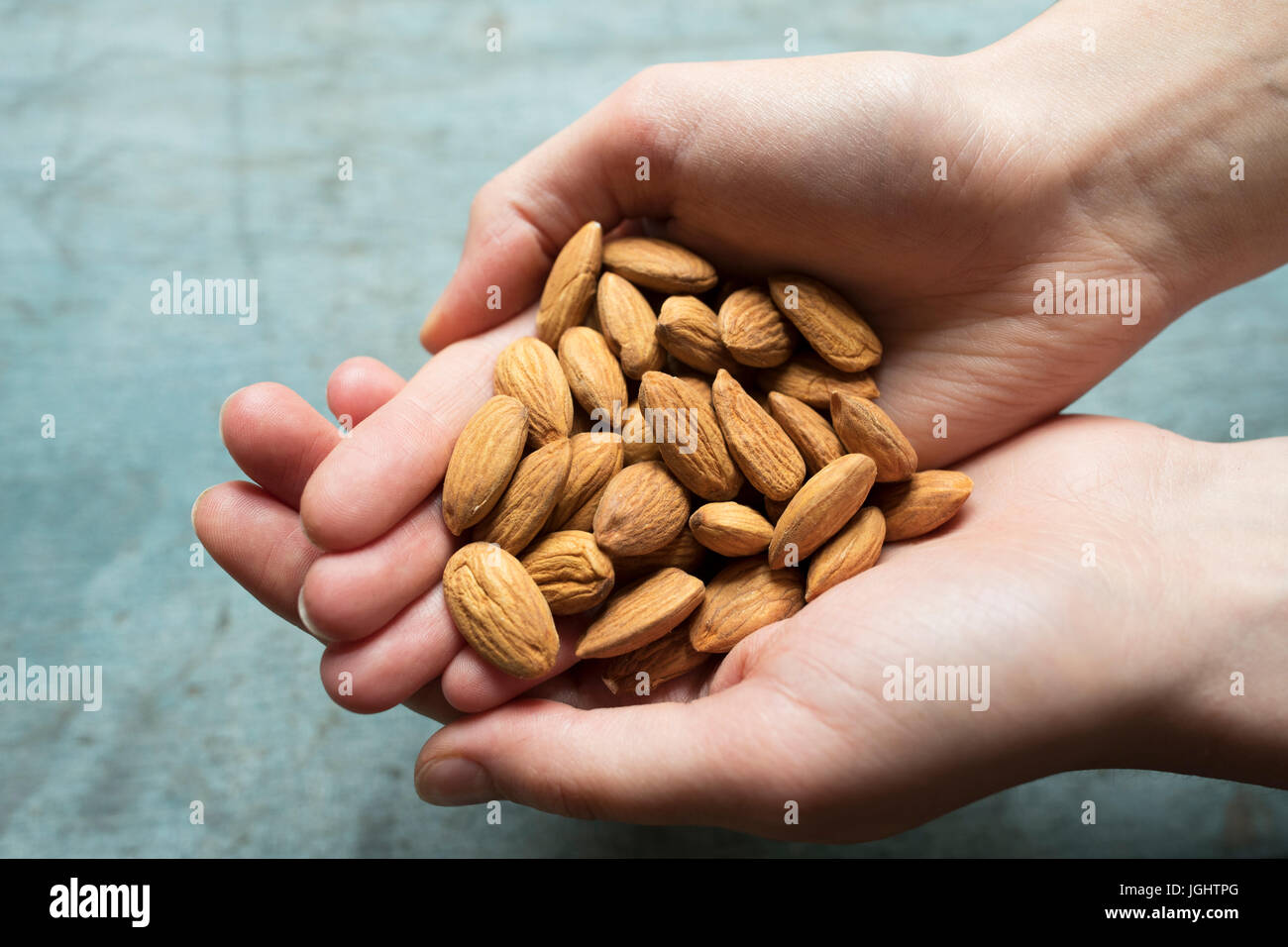 Close Up Of Woman Holding Handful Of Almonds Stock Photo - Alamy