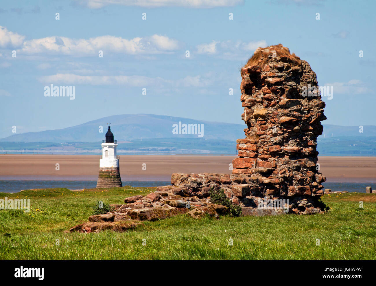 The lighthouse by the ruins Stock Photo - Alamy