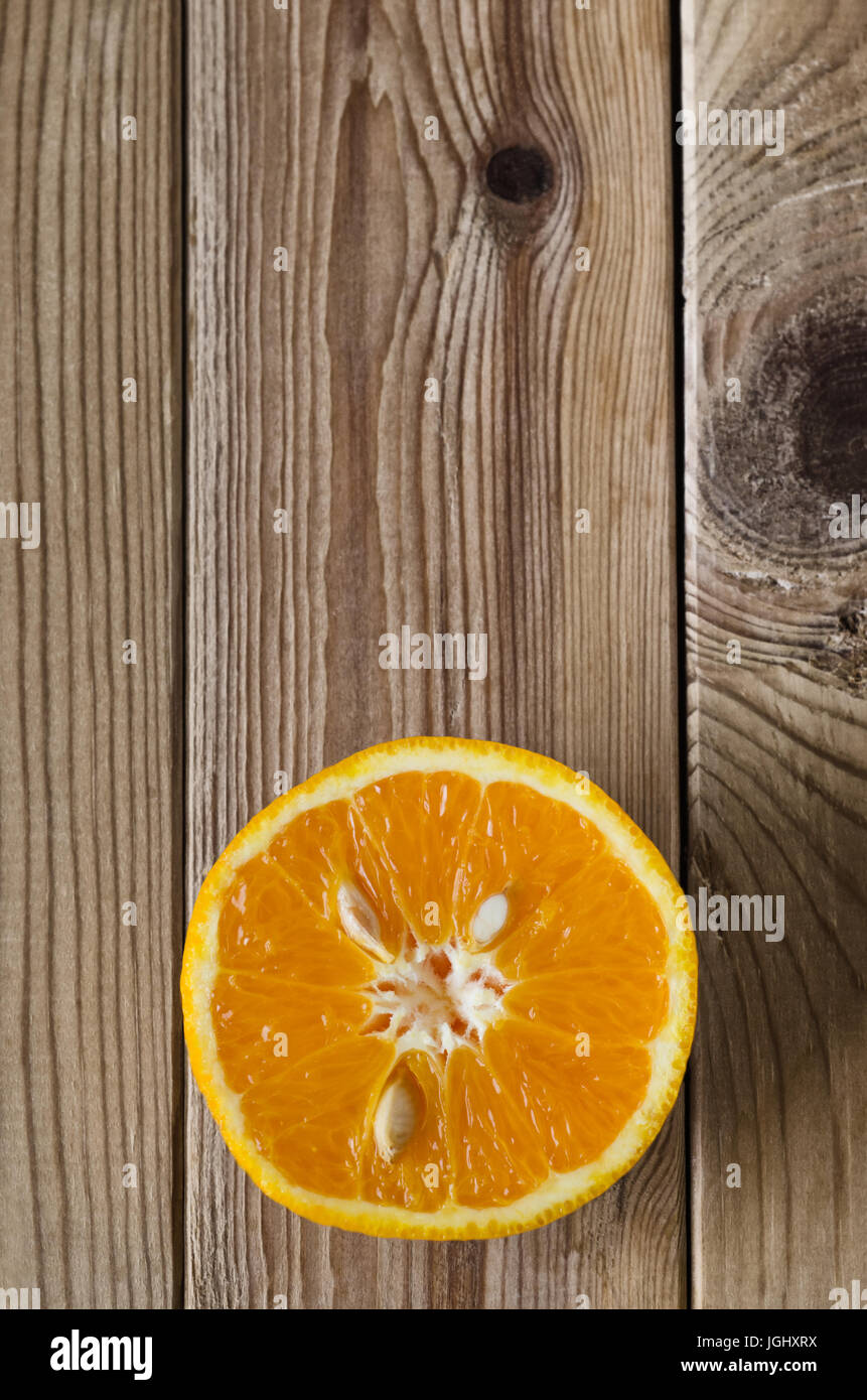 Overhead shot of an orange half with cut side facing upwards, flesh and ...