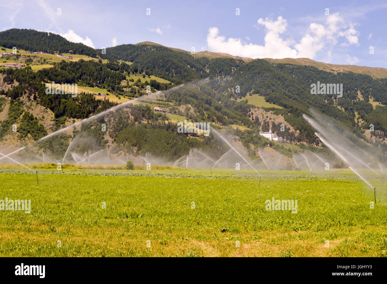 Automatic irrigation of crop fields in dolomites in Italy Stock Photo ...