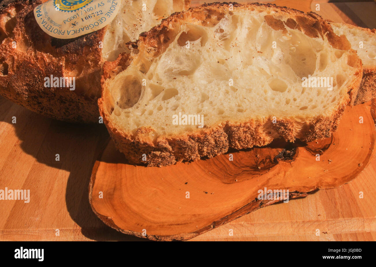 Loaf of sliced fresh bread from Genzano on wooden background Stock ...