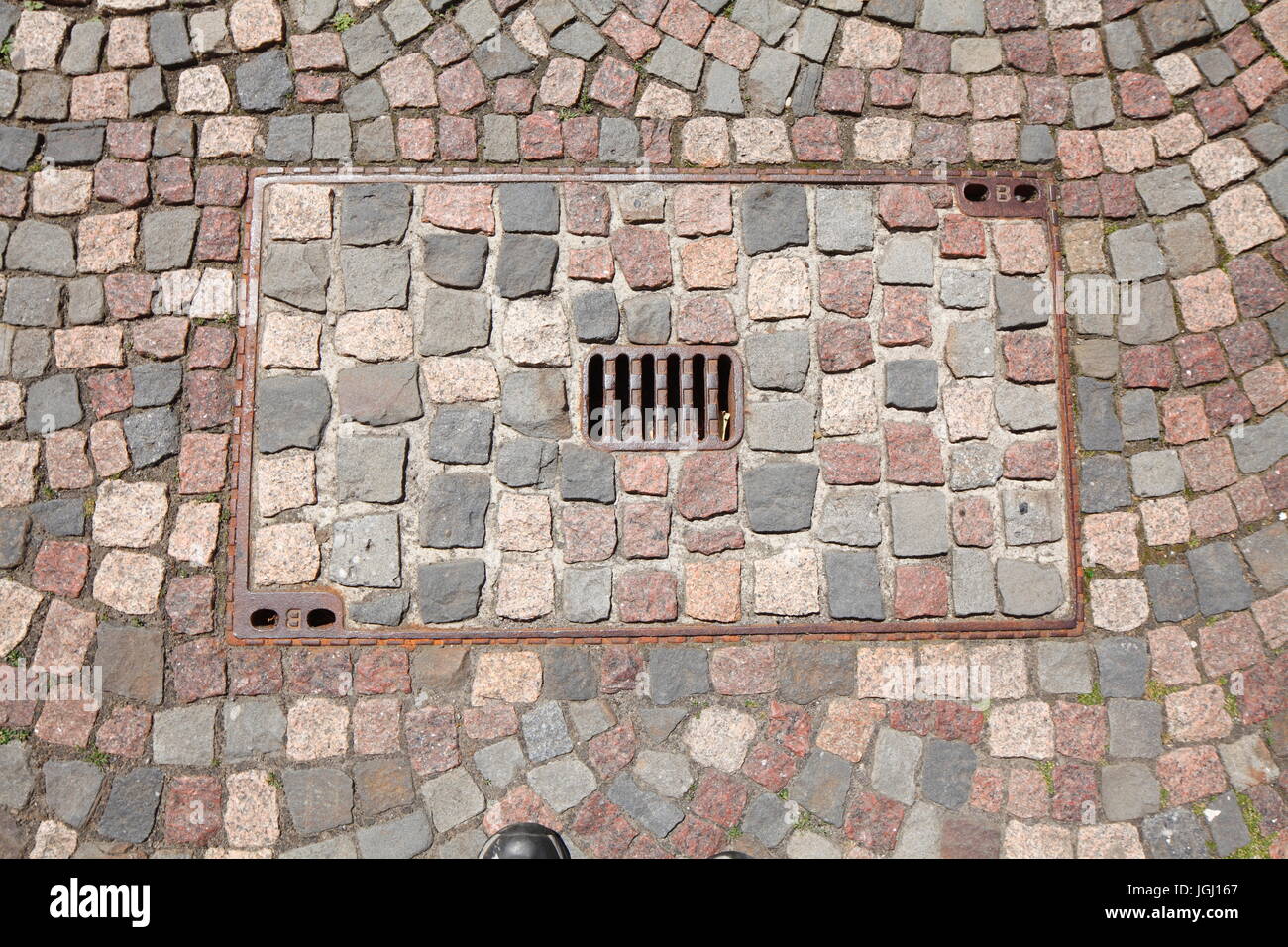 manhole cover and paving stones Stock Photo - Alamy