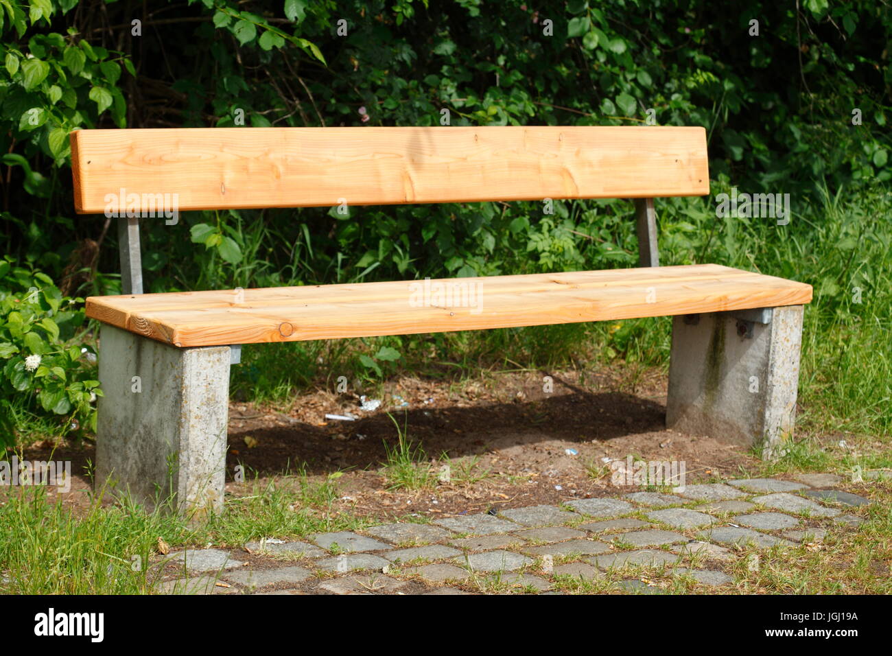 New Wooden Park Bench on a Meadow Stock Photo - Alamy