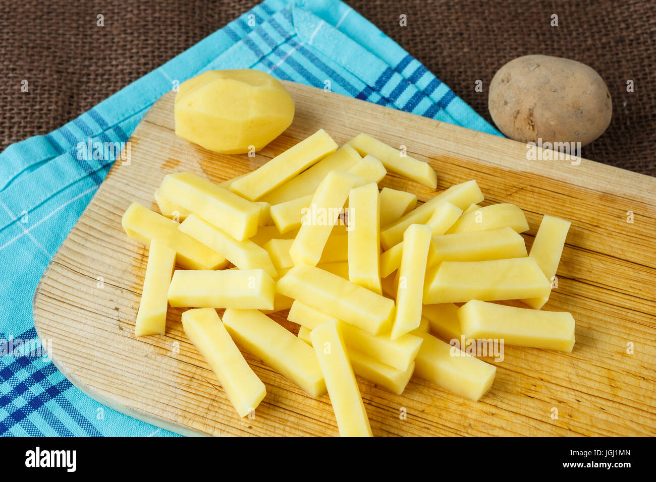 Raw potato sliced strips prepared for fries Stock Photo - Alamy