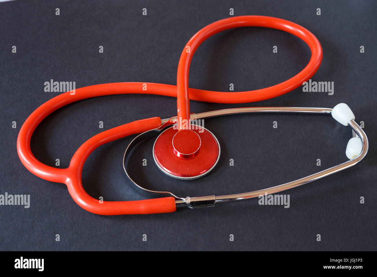 Red medical stethoscope on black background. Medical instrument for ...