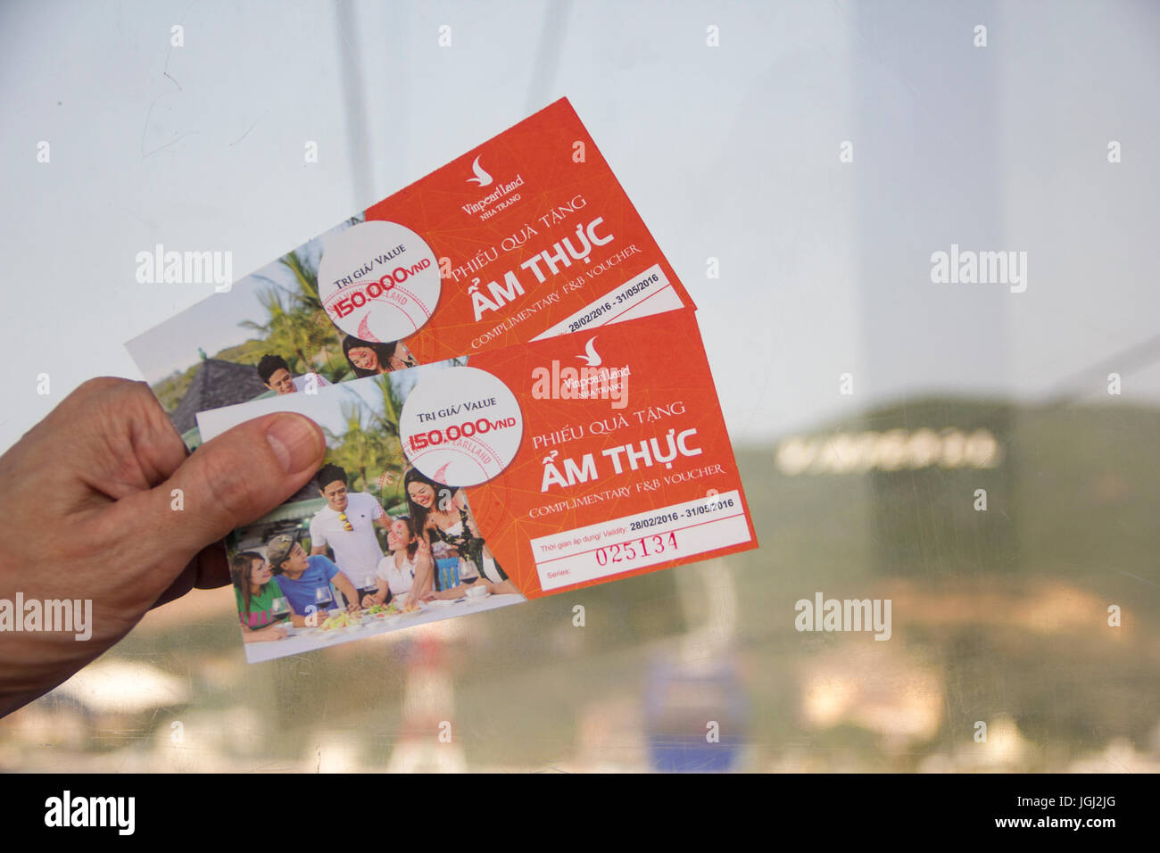 VINPEARL RESORT, NHA TRANG, VIETNAM, MARCH 5, 2016 - Hand holding two ...