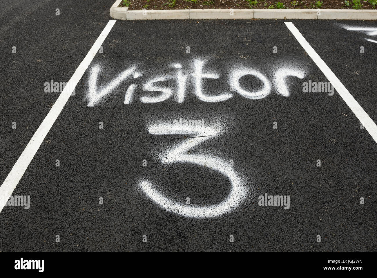 Hand painted visitor parking space in a car park Stock Photo - Alamy