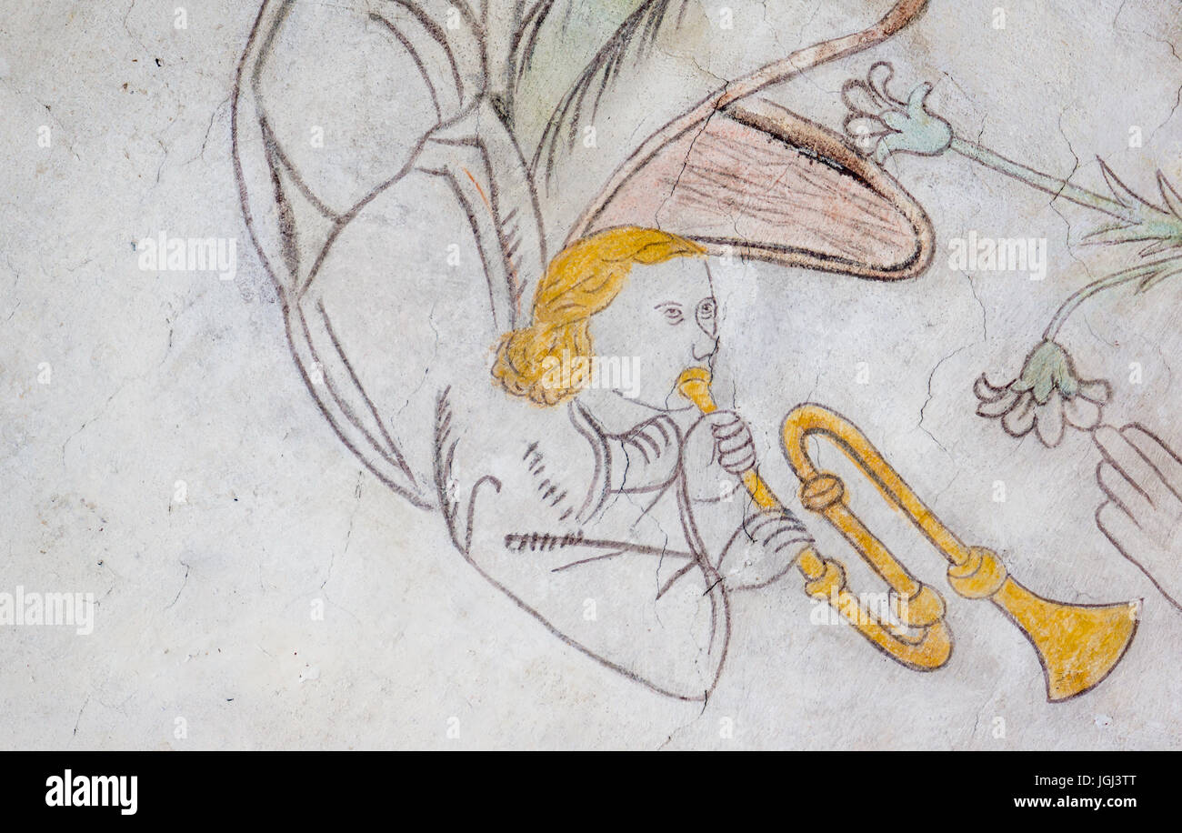 Angel playing the trumpet, medieval gothic fresco in Vinderslev church ...