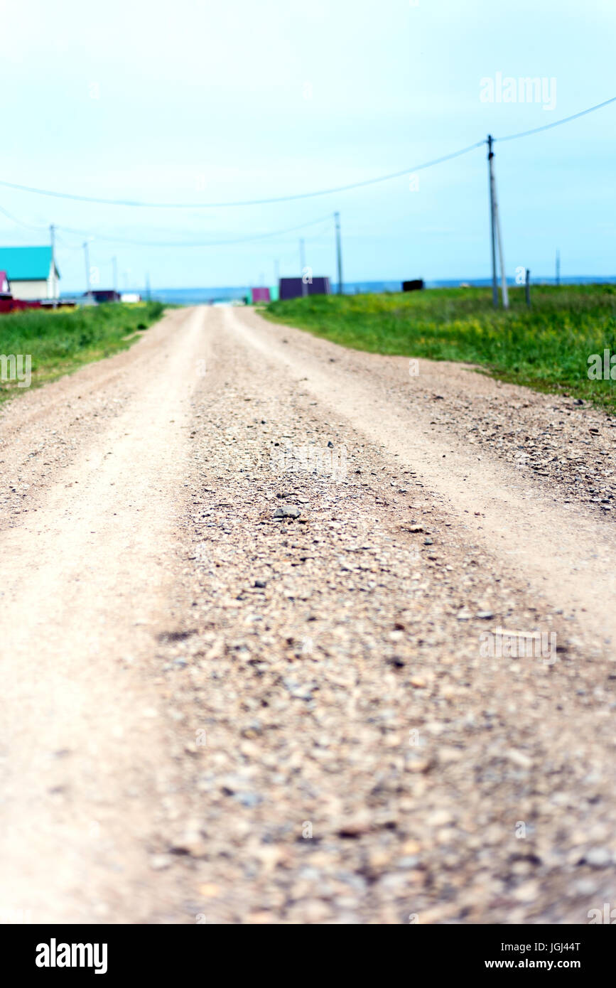 Dusty empty dirt road with no vehicles in summer sunlight Stock Photo ...