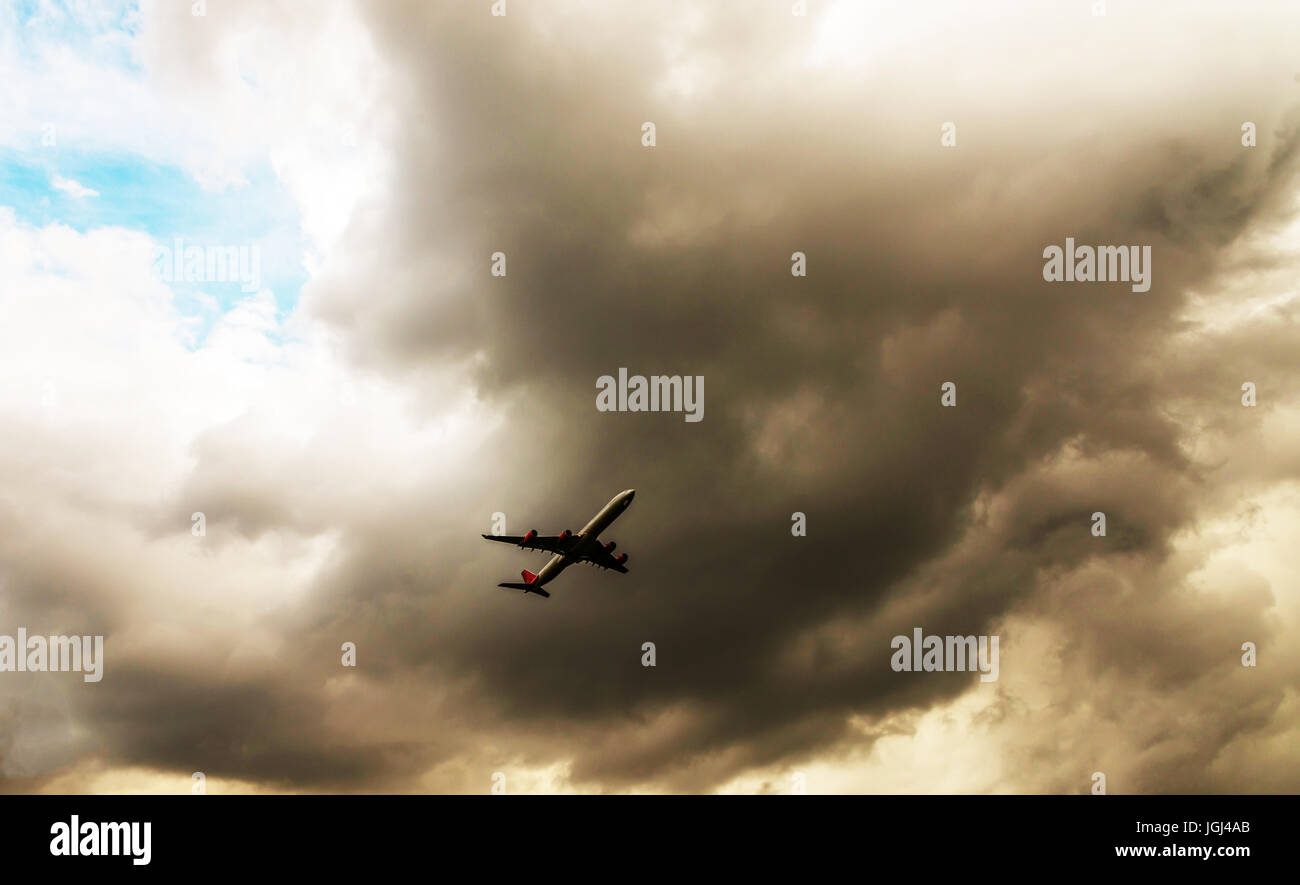 Passenger plane flying in the blue sky with clouds, cruise aircraft ...