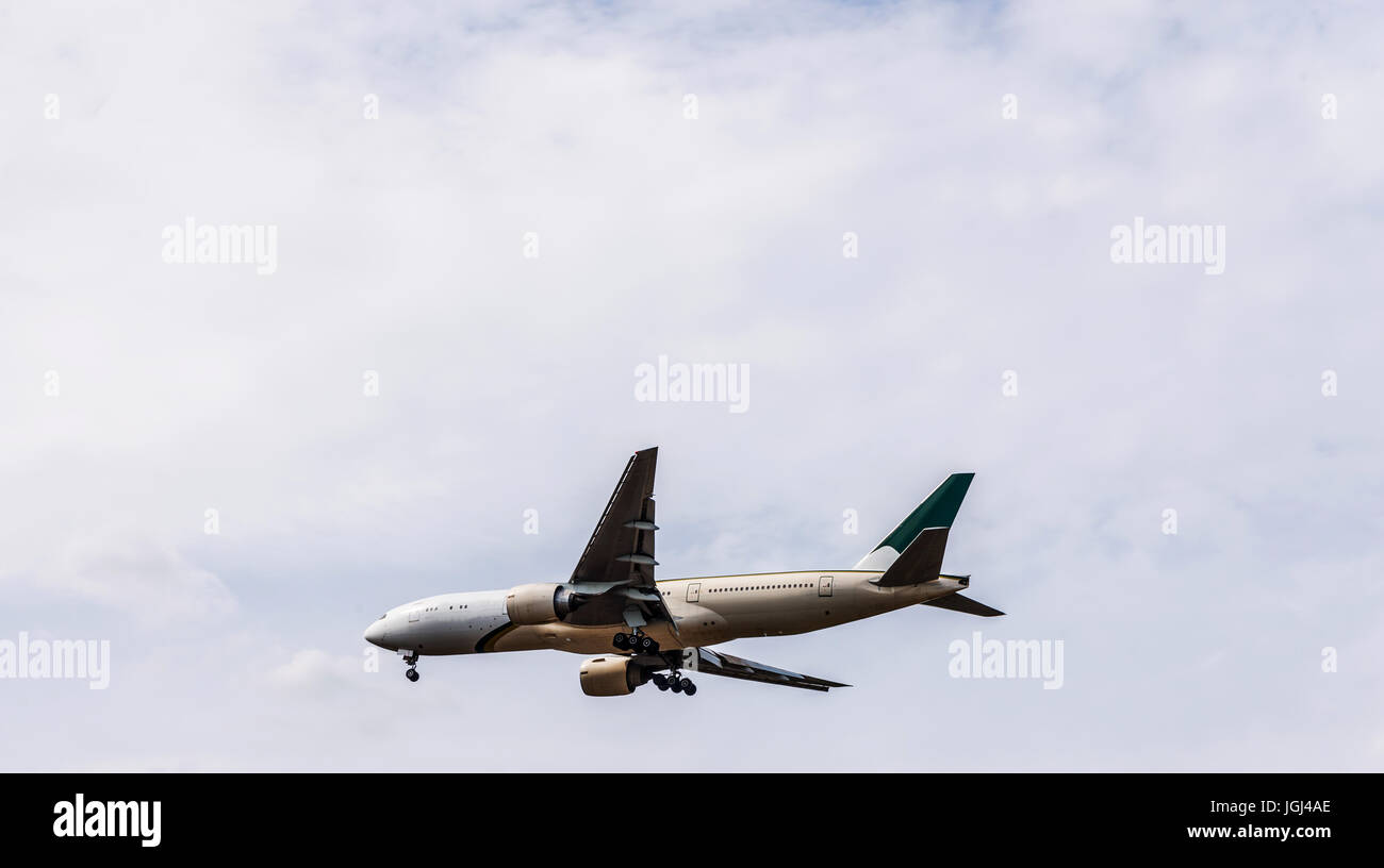 Passenger plane flying in the blue sky with clouds, cruise aircraft ...