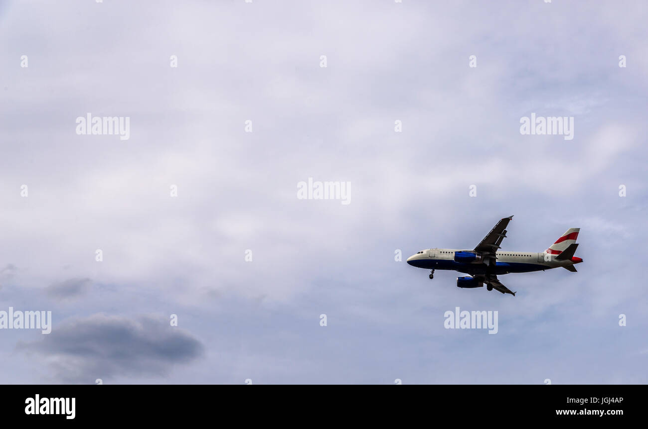 Passenger plane flying in the blue sky with clouds, cruise aircraft ...