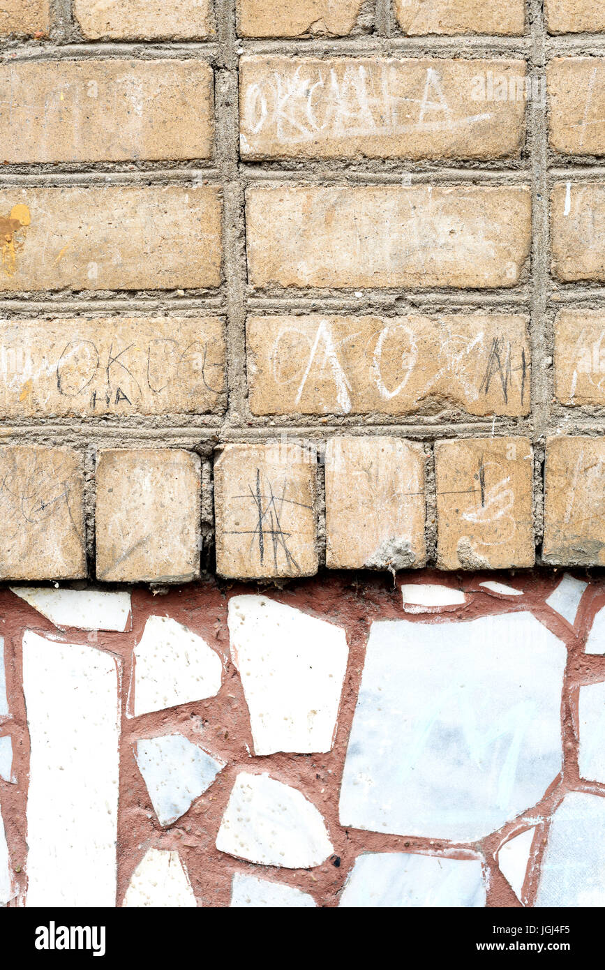Old faded brick wall with a crazy paving style tiling of light ...