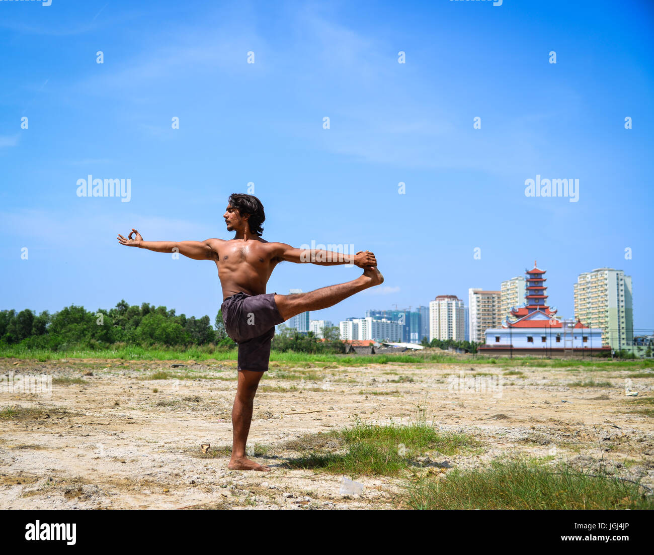 Young Indian muscular man doing yoga exercise in the park Stock Photo ...