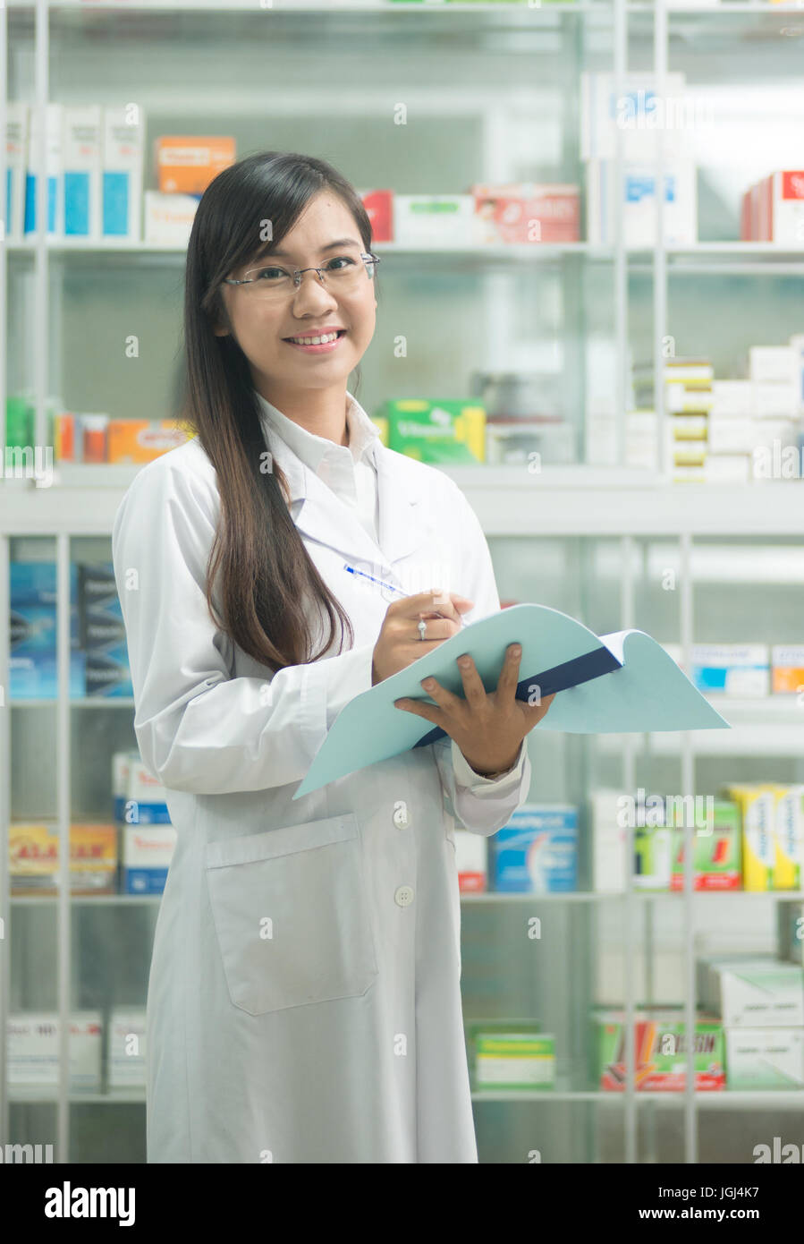 Portrait of a smiling medical personnel or doctor in hospital pharmacy ...