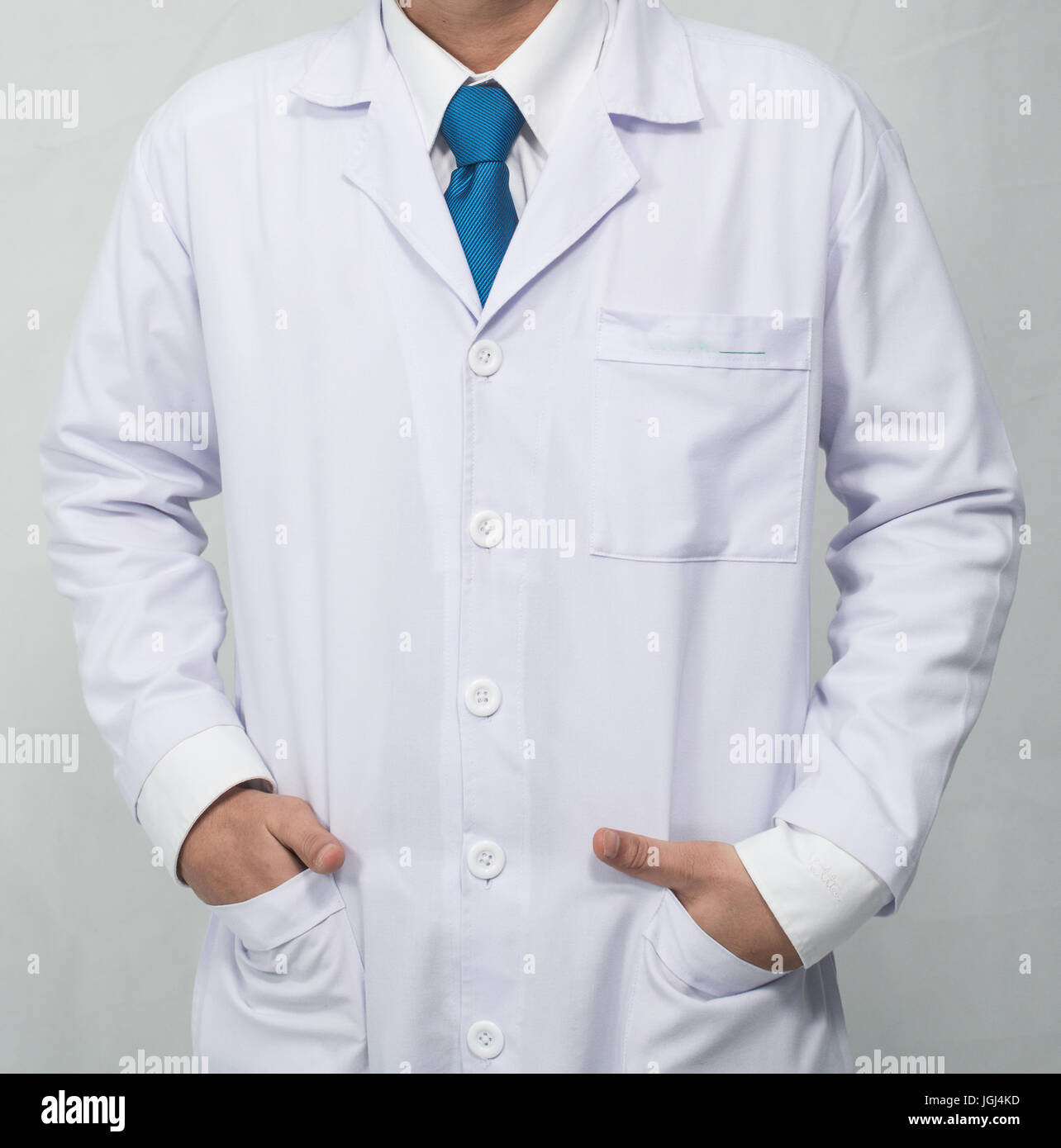 Doctor (a young man) in white uniform at the studio. Half body Stock ...