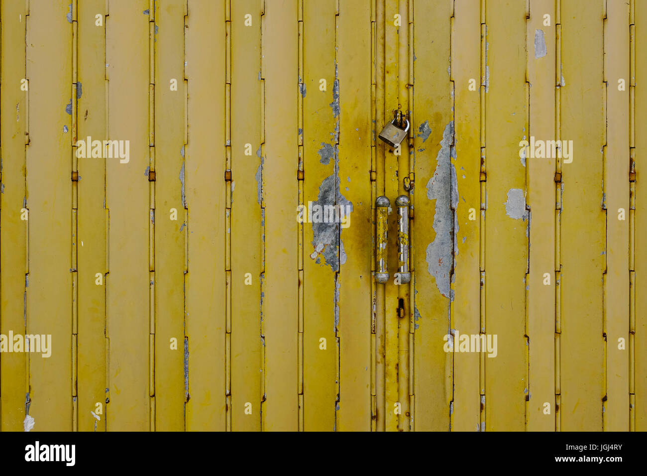 Yellow old steel door with lock at ancient town. Close up Stock Photo ...
