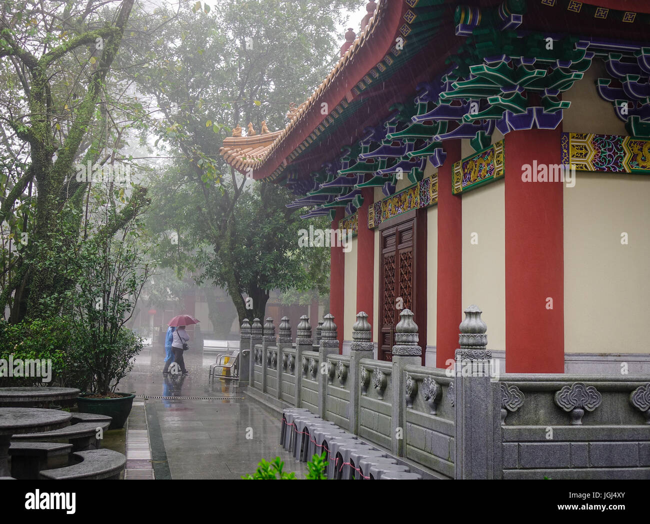People visit Po Lin Monastery at rainy day in Hong Kong. Po Lin is an ...