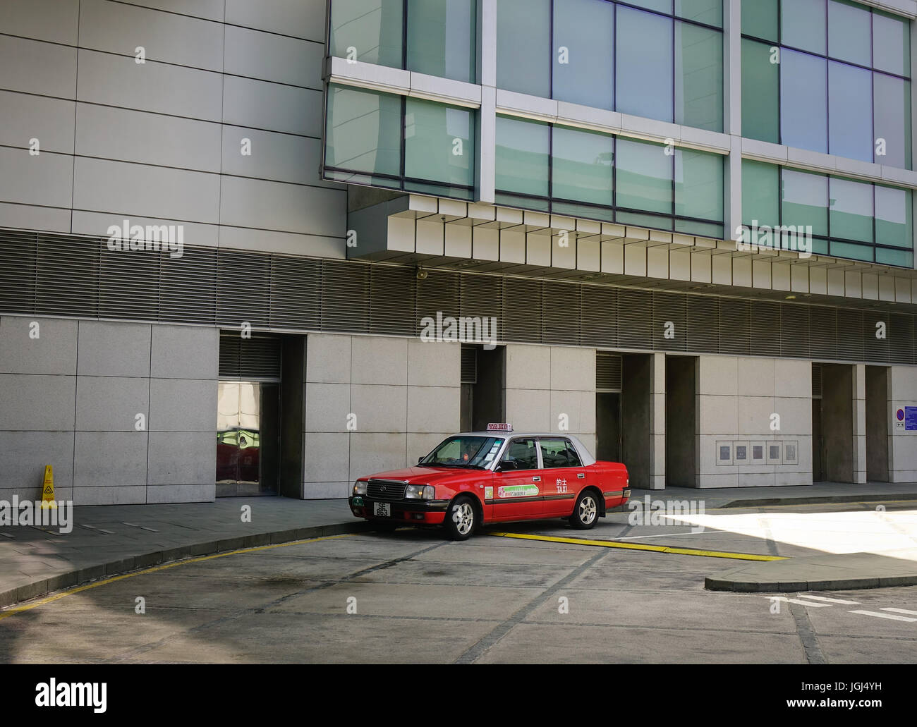 Hong Kong - Apr 1, 2017. A red taxi parking at a shopping mall in Hong ...