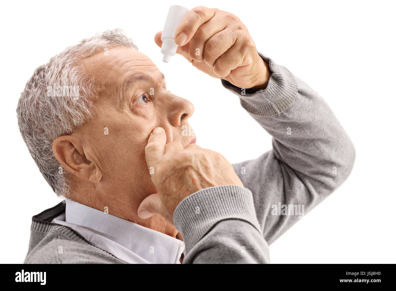 Mature man applying eye drops isolated on white background Stock Photo ...
