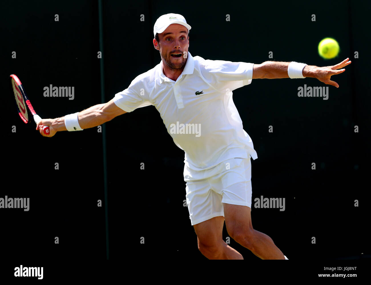 Roberto Bautista Agut in action against Kei Nishikori on day five of the Wimbledon Championships ...
