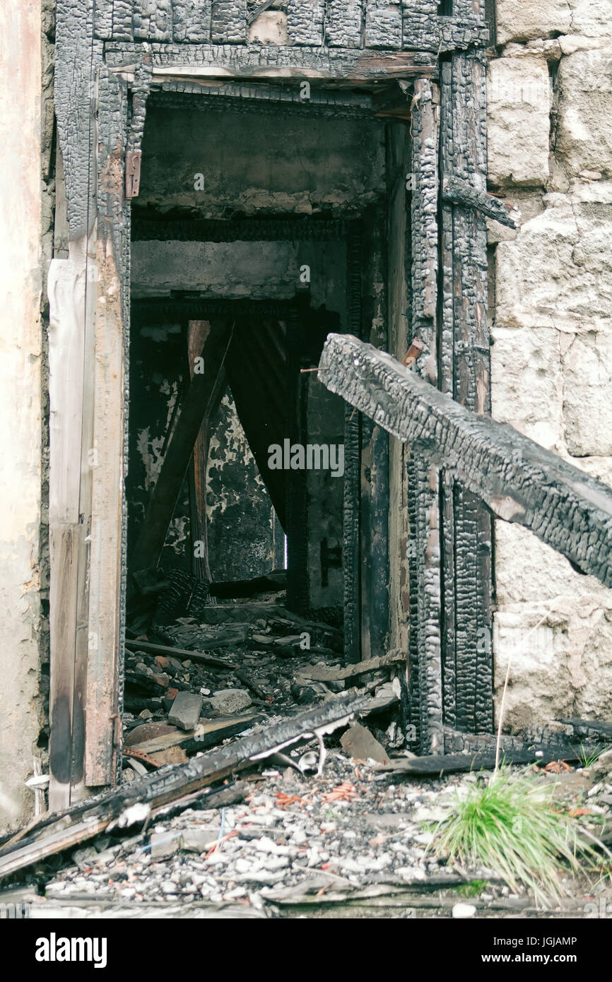 ruins of an abandoned houses. This old house had fire, charred door ...