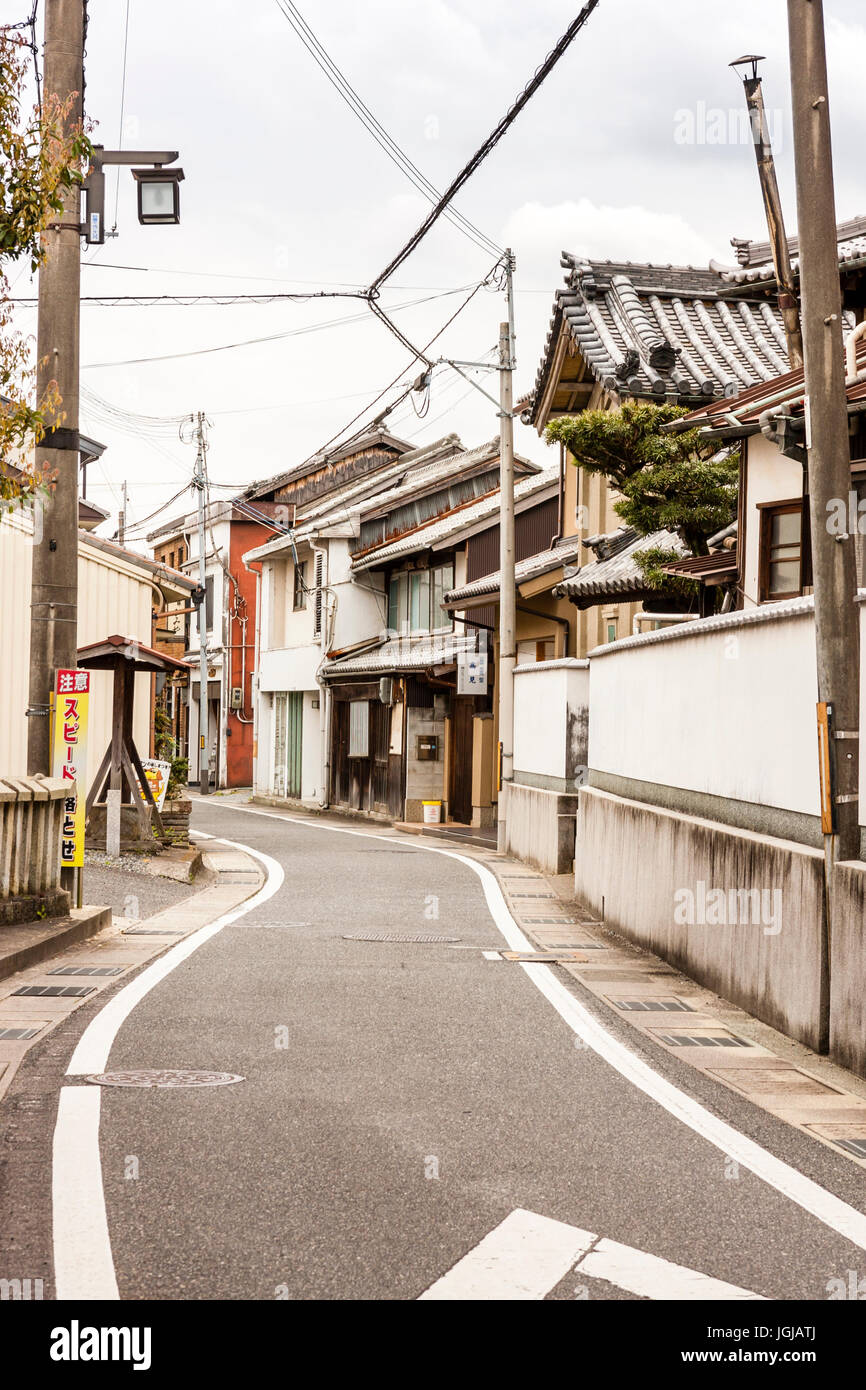 Japan, Tatsuno. Typical narrow single lane road through rural town with ...