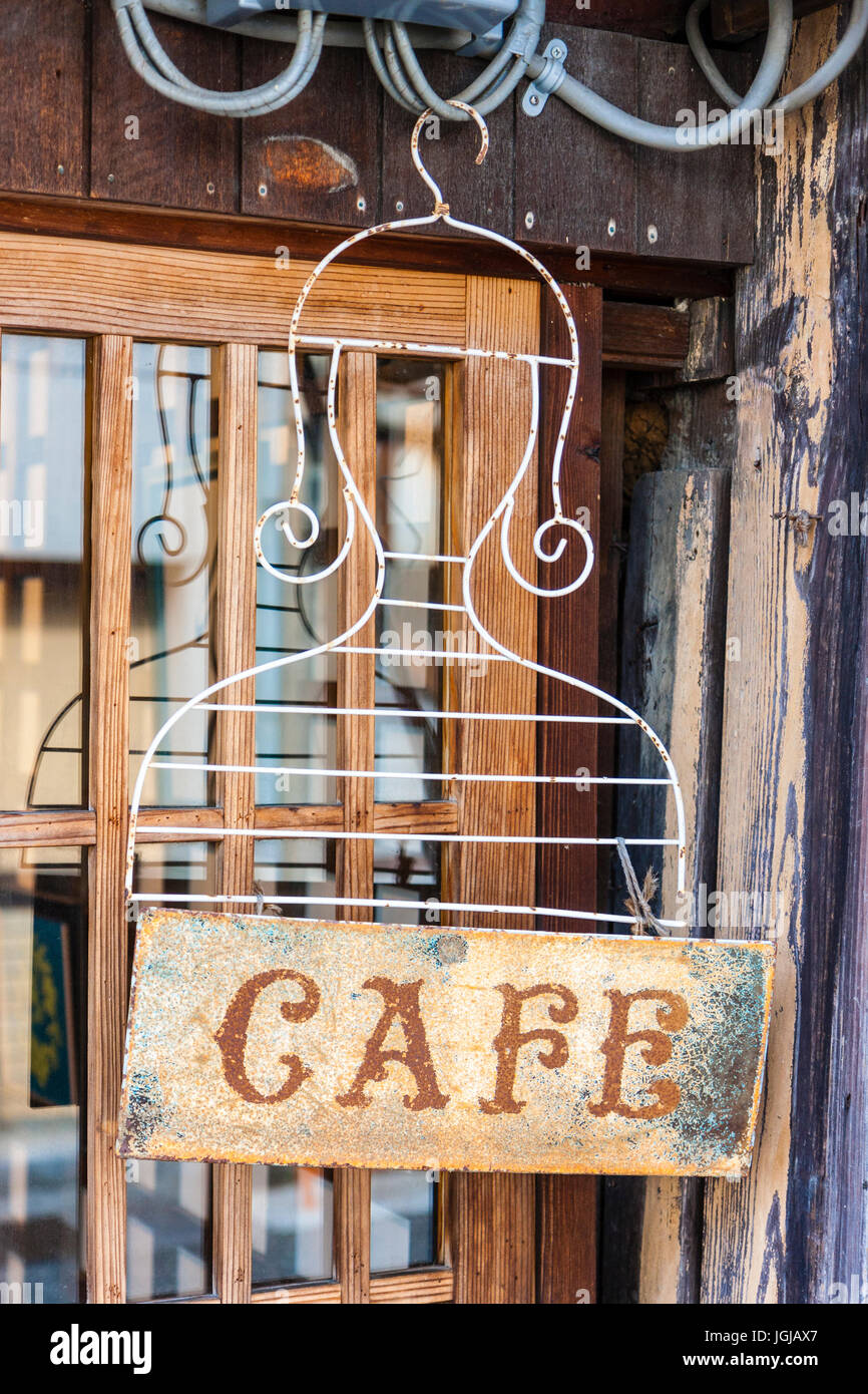 Japan, Tatsuno. Wire cafe sign in the form of the head and shoulders of ...