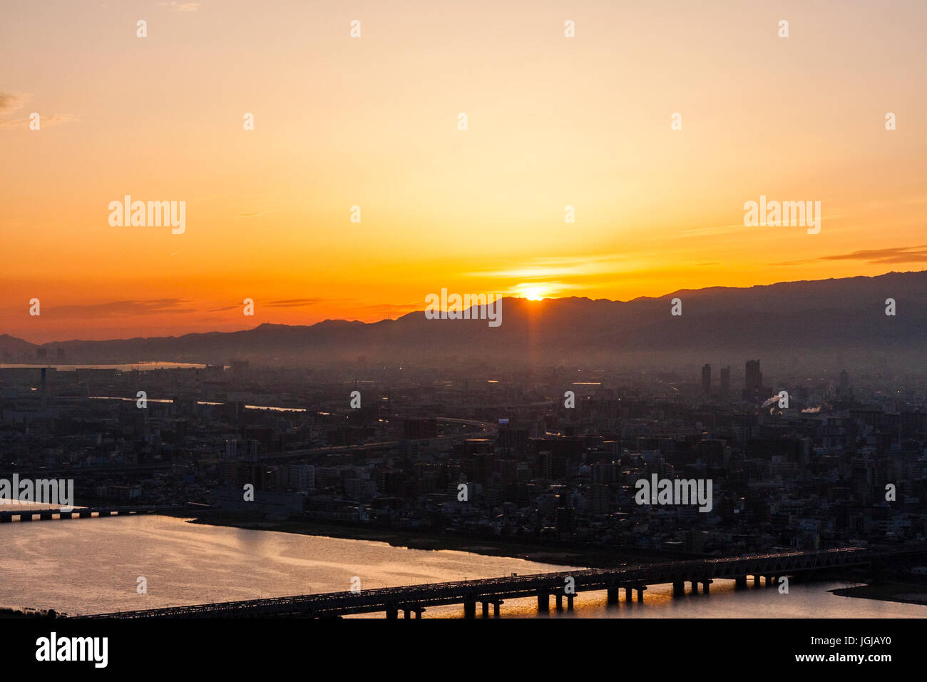 Aerial view. Yodogawa river and Osaka city with mountains at sunset ...