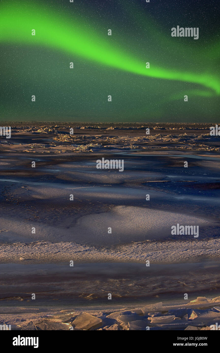 Northern lights over ice sea. winter and night in cold green lights ...