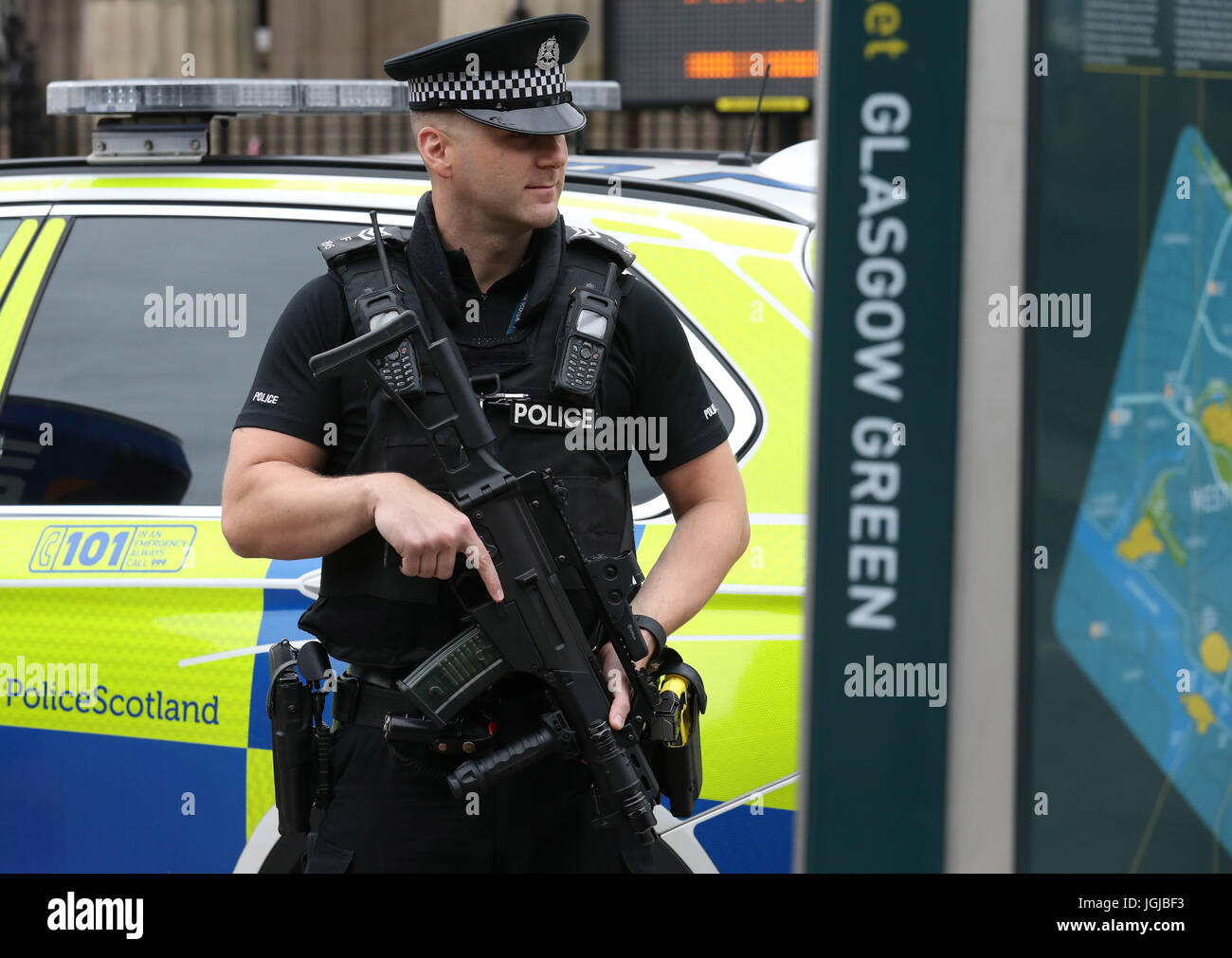 An armed police officer on duty near Glasgow Green as fans arrive for ...