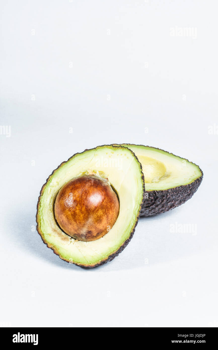 Avocado cut in half Stock Photo - Alamy