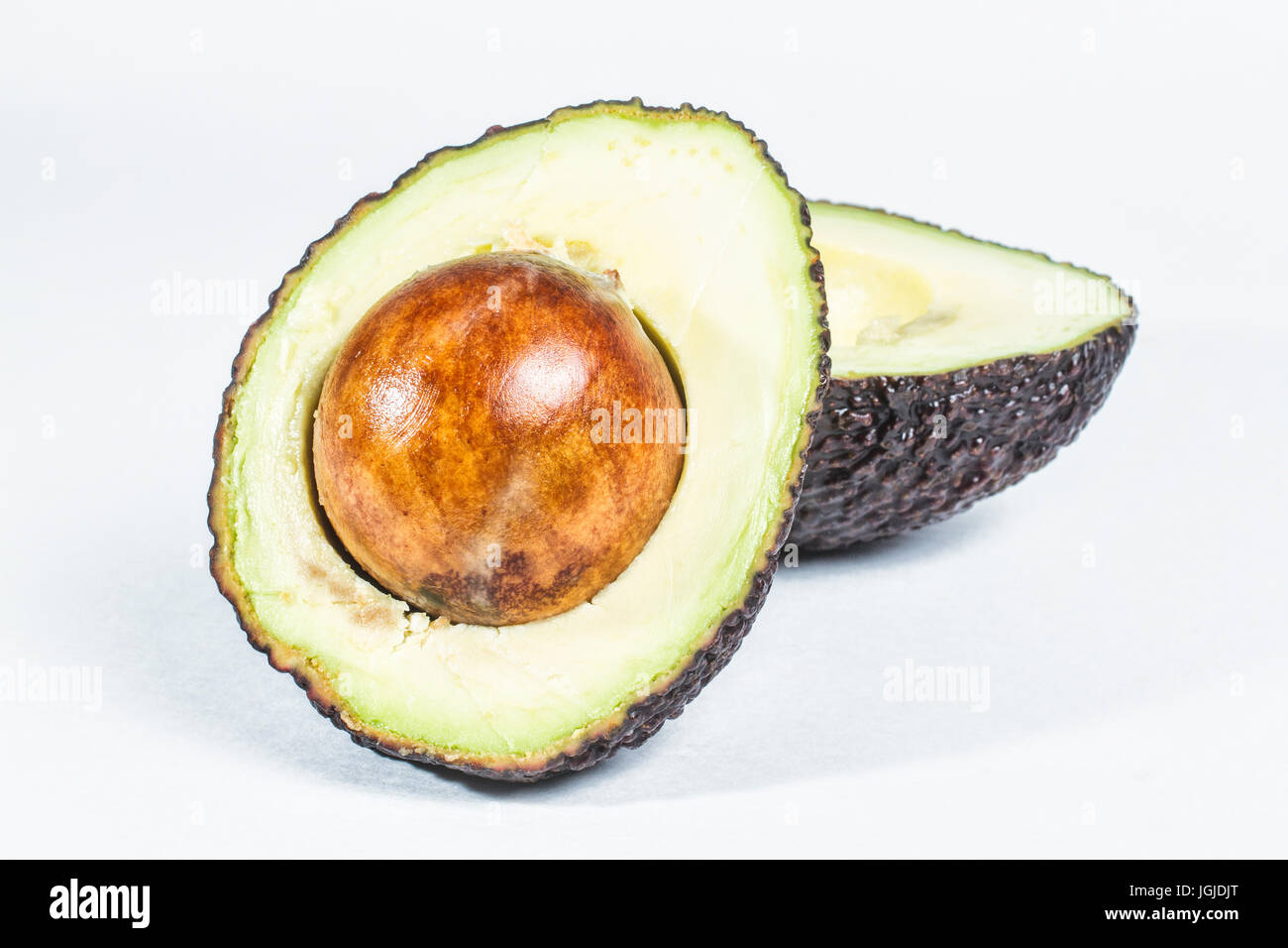 Avocado cut in half Stock Photo - Alamy
