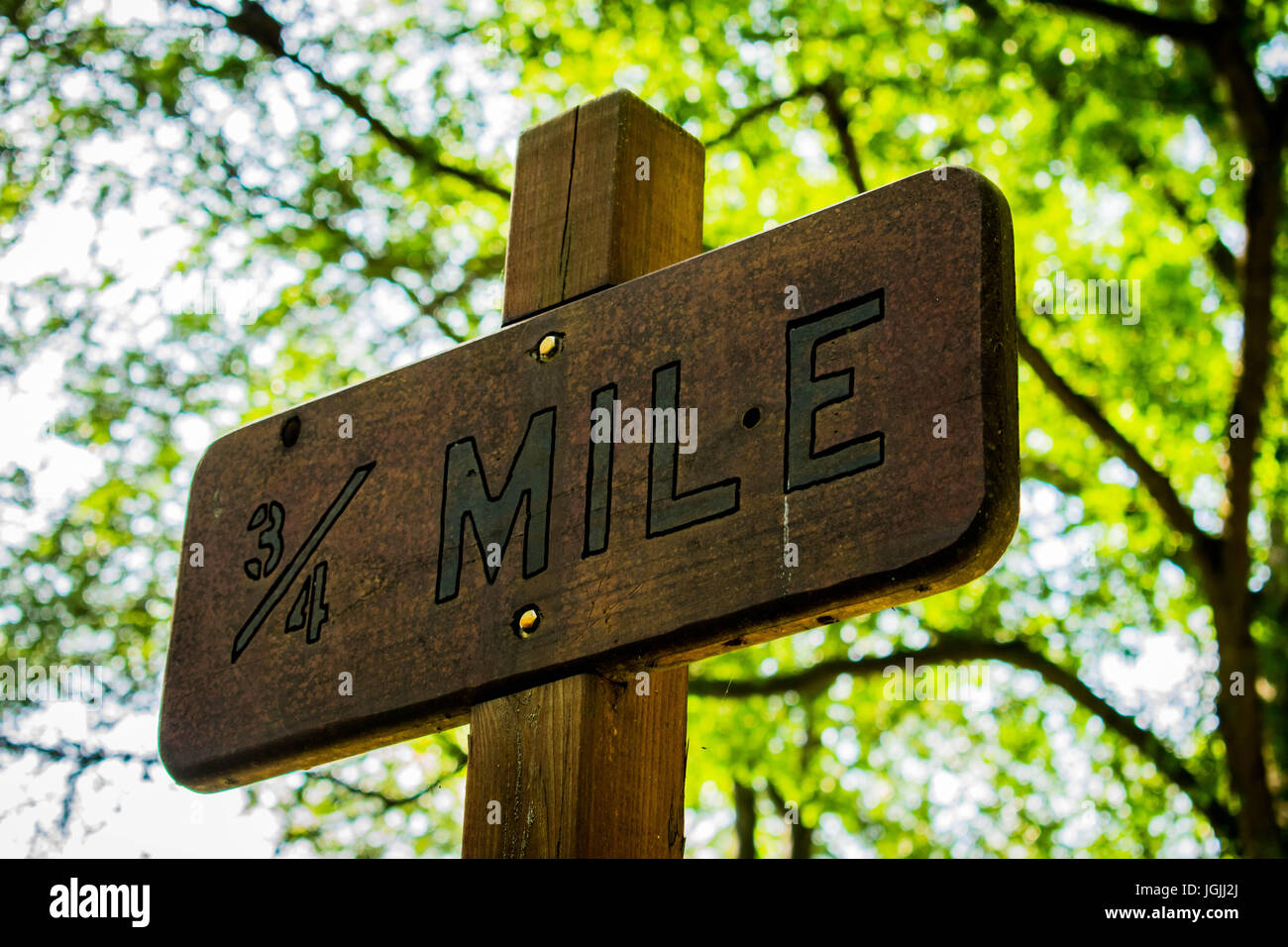 A trail sign that read 3/4 mile. Live life one mile at a time ...