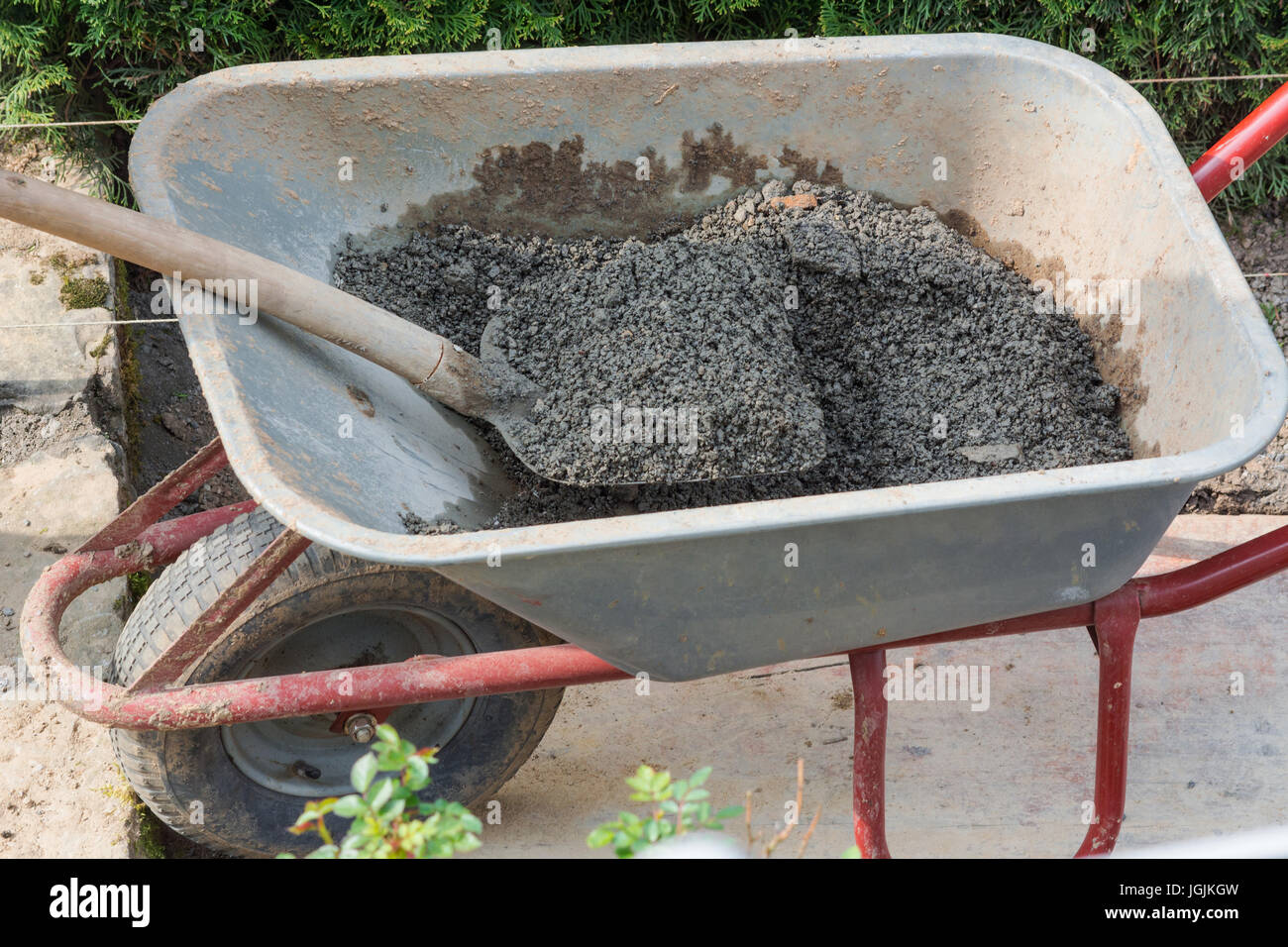 Wheelbarrow on a construction site filled with concrete Stock Photo - Alamy