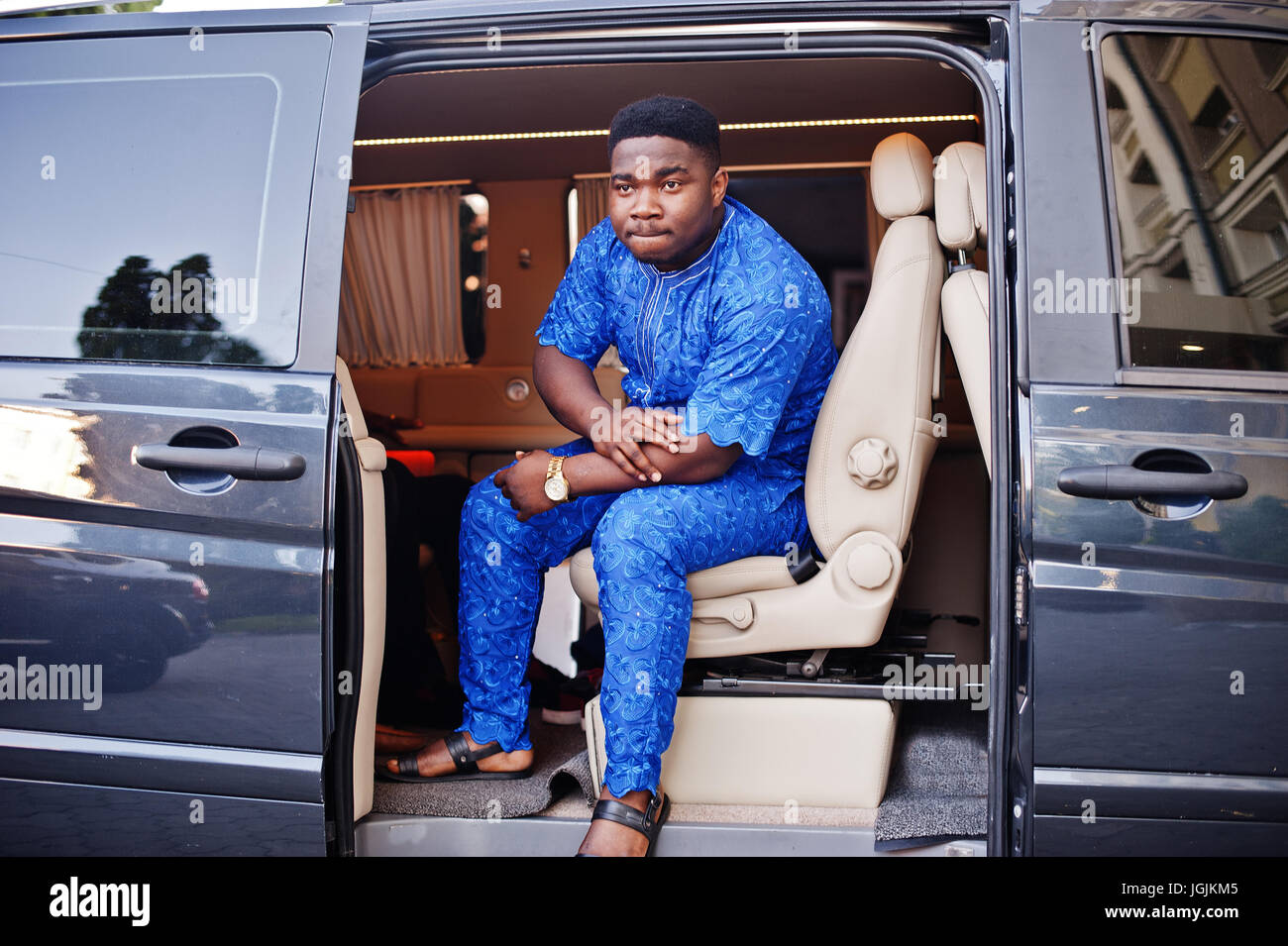 Black man wearing cool traditional clothes sitting in the minivan Stock ...