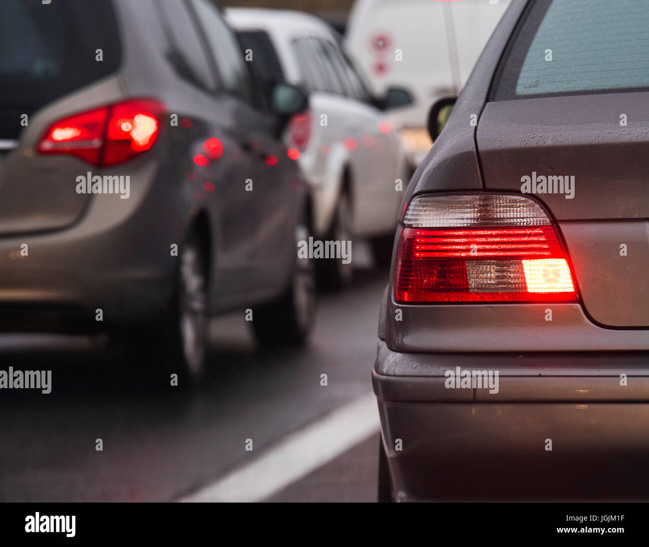 Detail of the gray car, a red stop light Stock Photo - Alamy