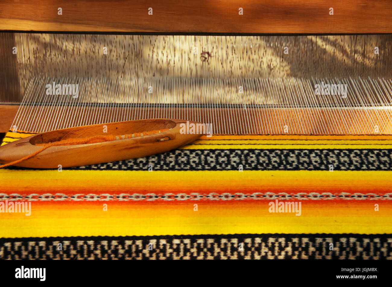 Crafts. Hand loom with many colorful woolen threads Stock Photo - Alamy