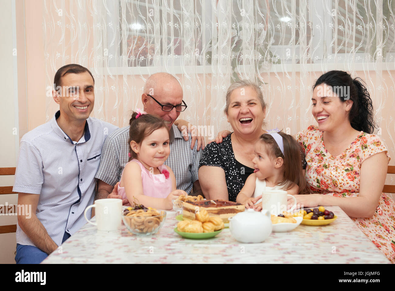 big family drinking tea in dining room Stock Photo - Alamy
