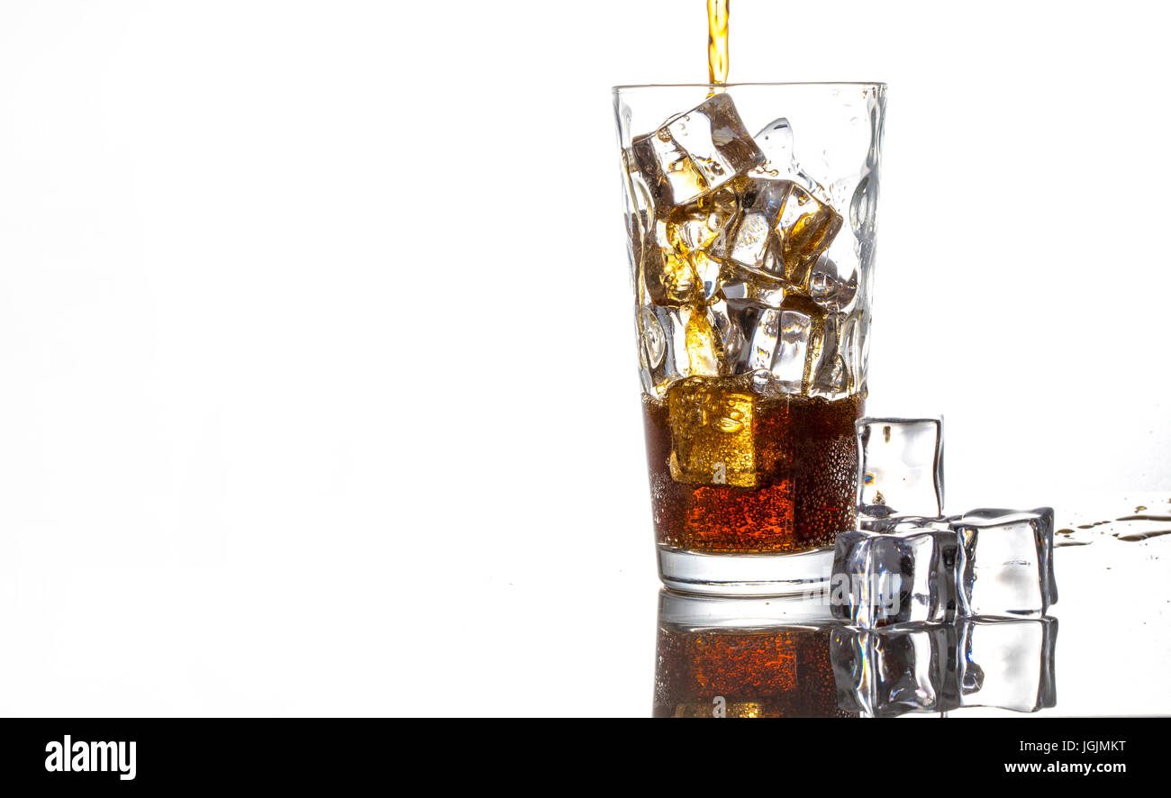 Highball glass with Ice Cubes and drink Stock Photo - Alamy