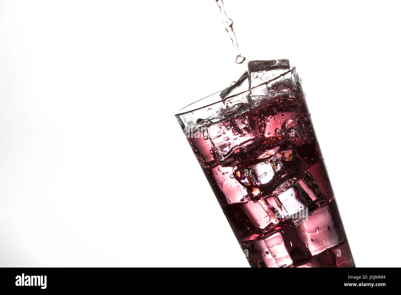 Highball glass with Ice Cubes and drink Stock Photo - Alamy