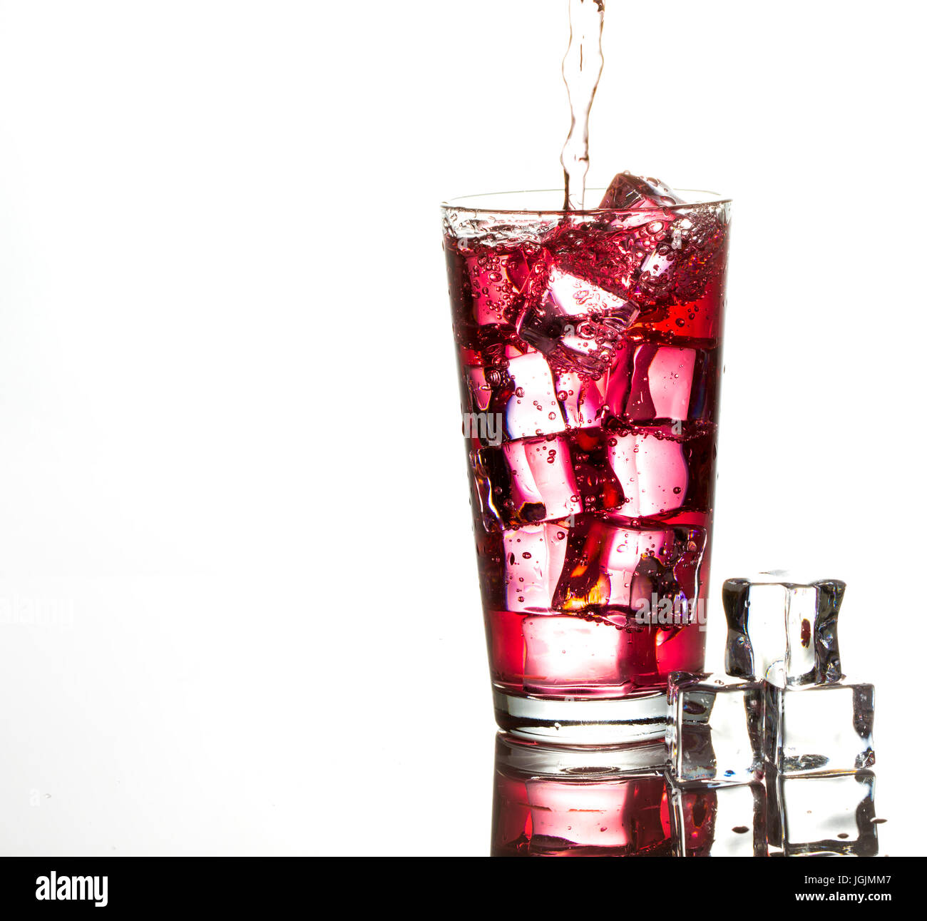 Highball glass with Ice Cubes and drink Stock Photo - Alamy